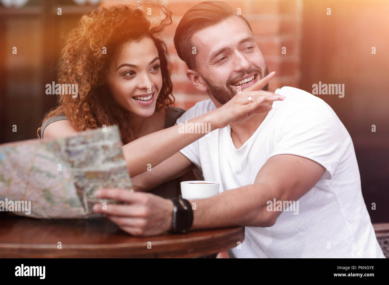 A picture of tourists looking at map in a cafe Stock Photo - Alamy