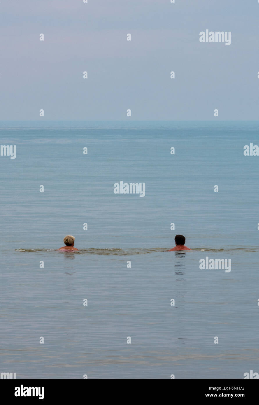 two people swimming in a calm sea Stock Photo - Alamy