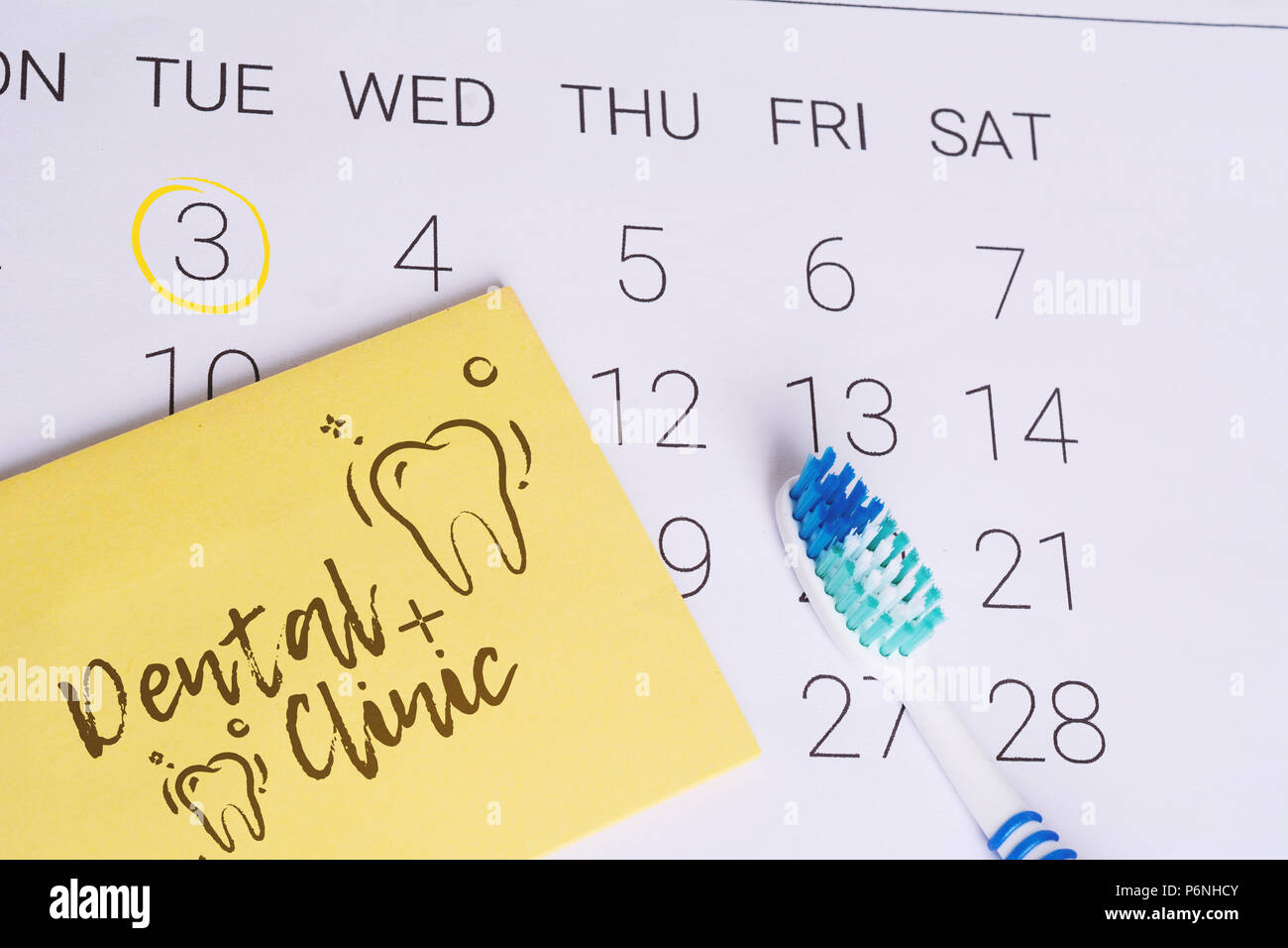 Calendar with a marked date and toothbrush to remind dentist ...