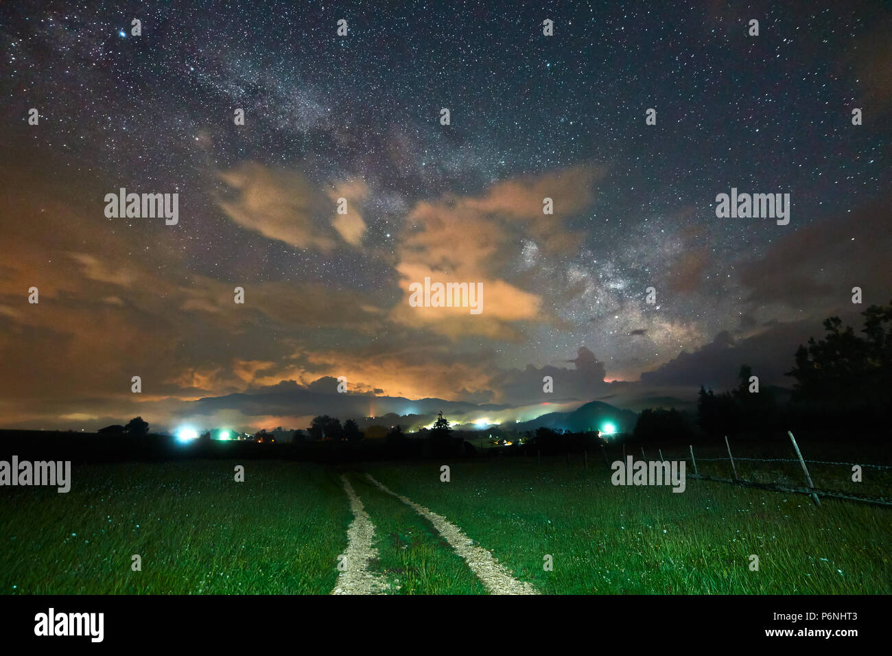 Landscape with night sky and a dirt road Stock Photo - Alamy