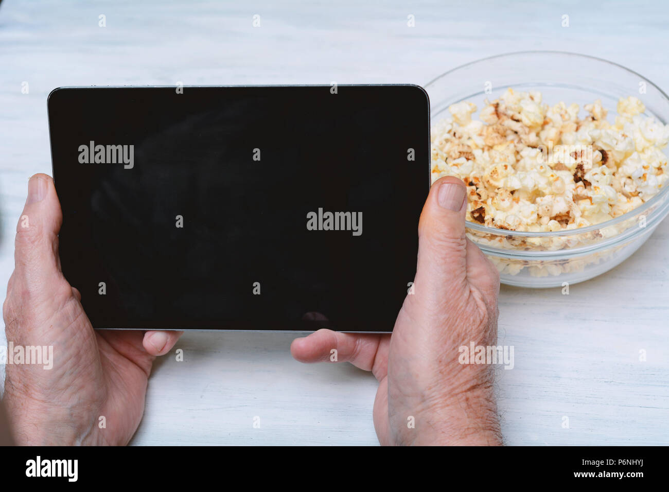 Popcorn in bowl and tablet wth black screen. Entertainment concept ...