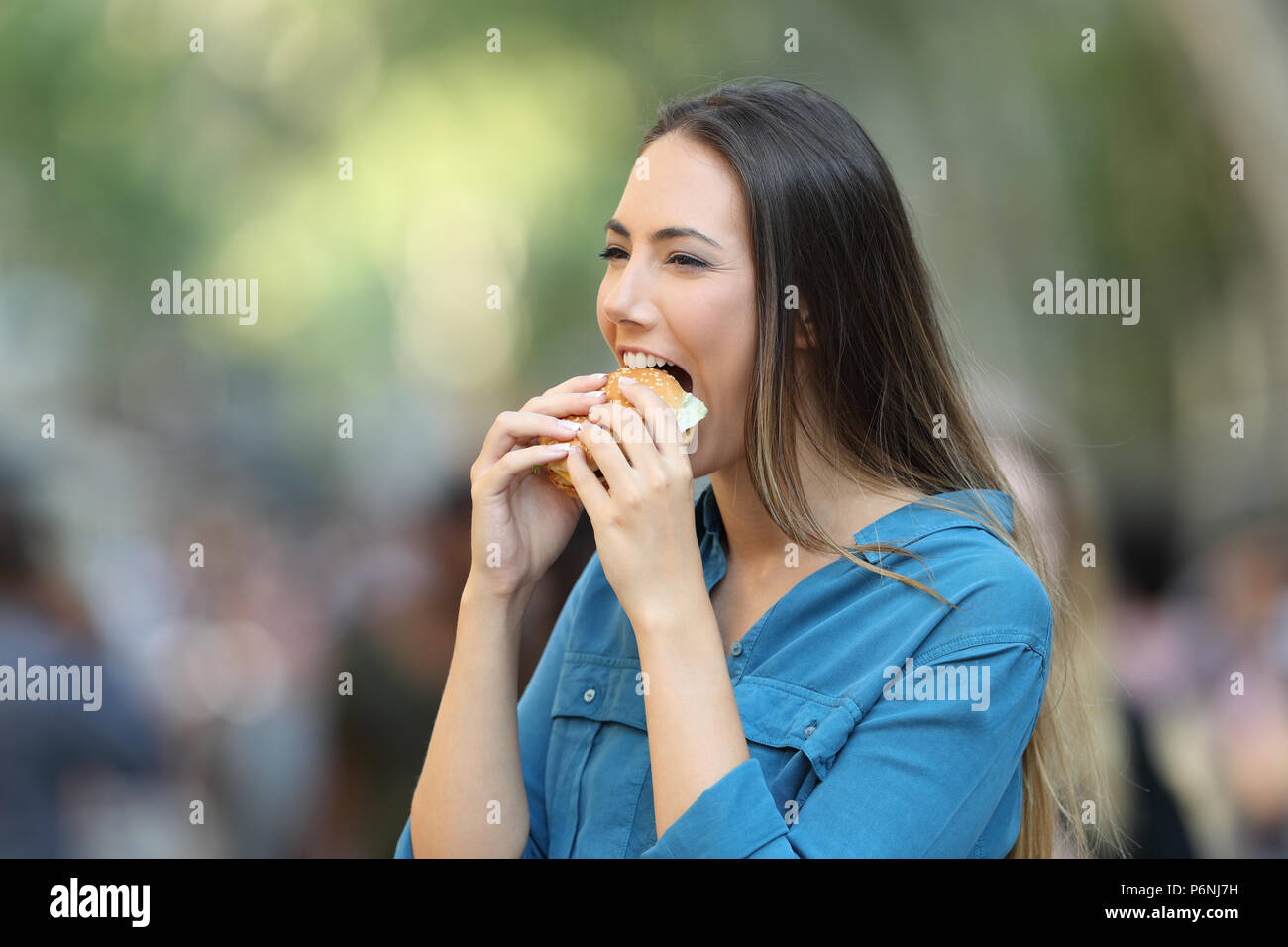Woman eat sandwich walking hi-res stock photography and images - Alamy