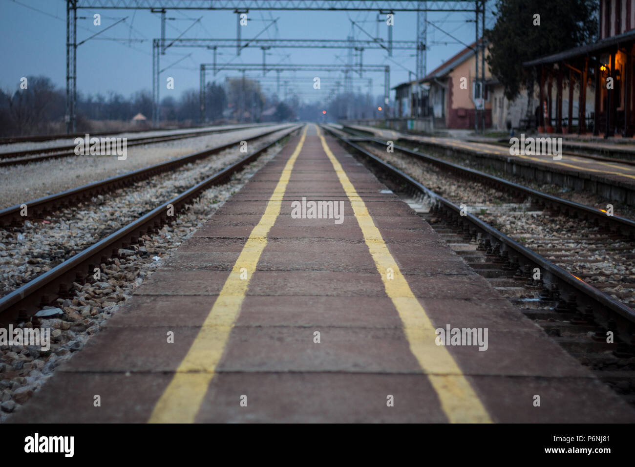 Old train station platform with its distinctive yellow safety lines on ...