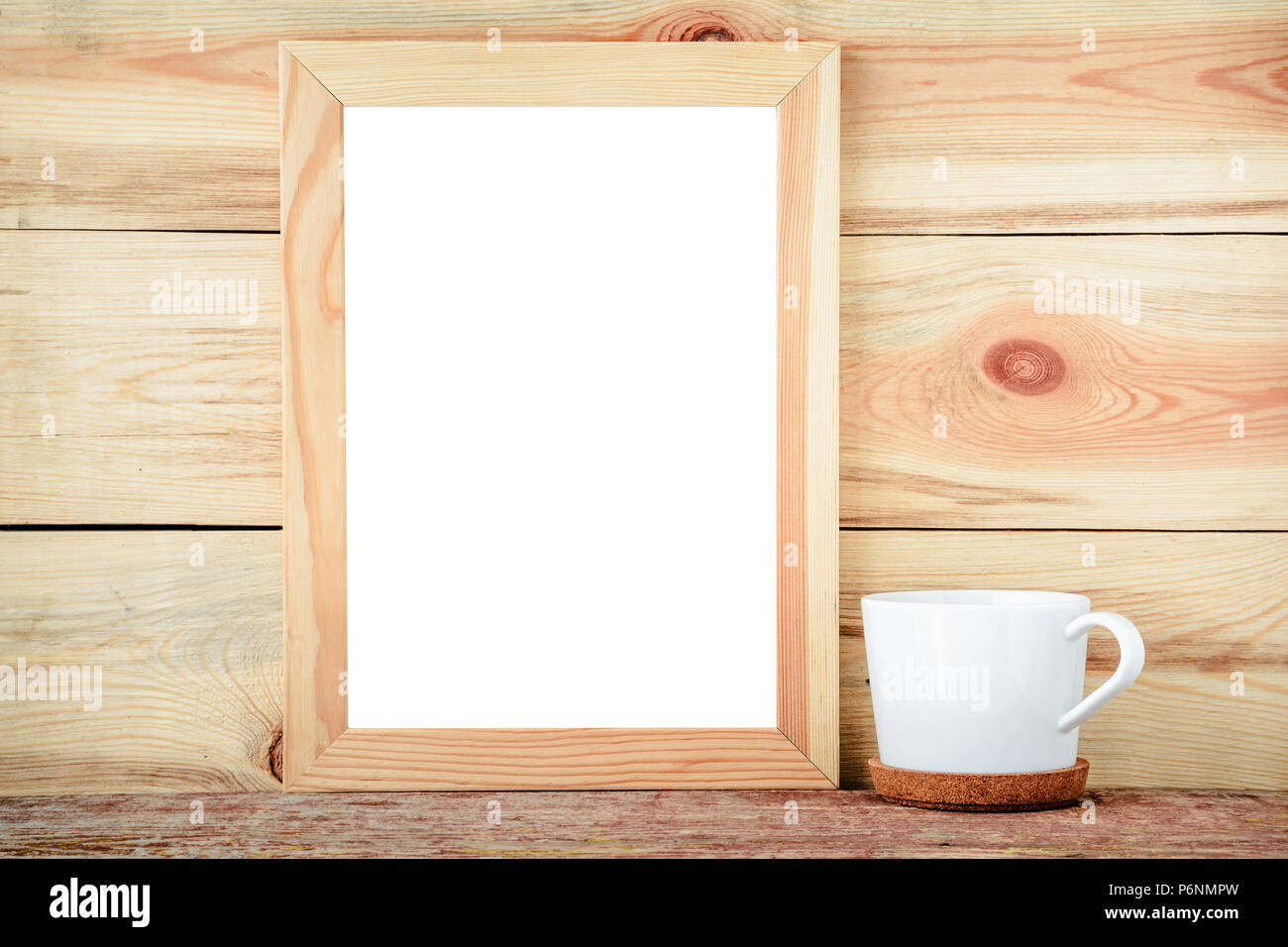 empty frame and white cup on a wooden background. Layout for design ...