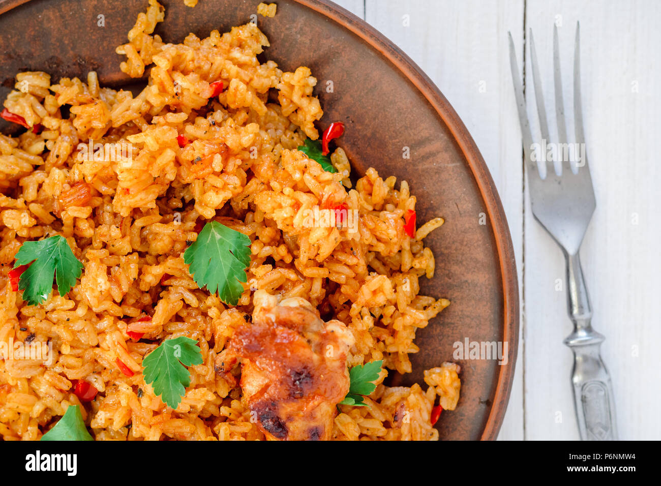 Fried rice with vegetables and chicken baked in sauce, top view. Asian ...