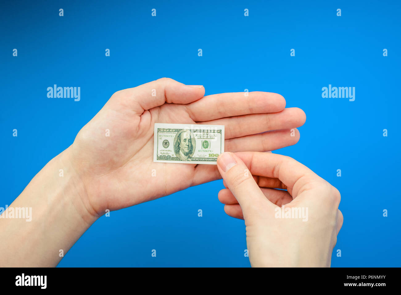 Illustration for inflation. Woman's hand holding small banknote of US ...