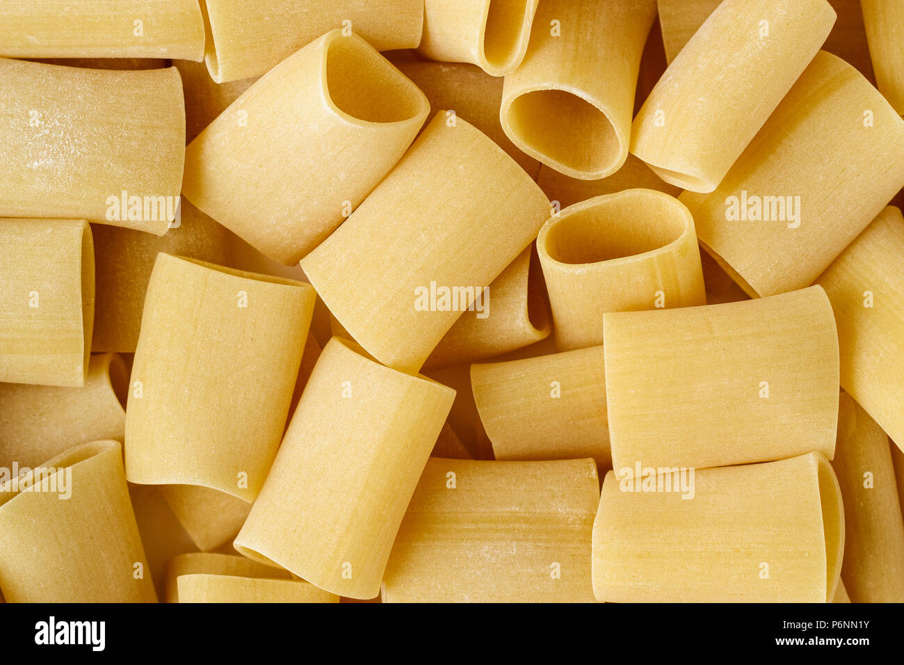 Thick tubes of pasta as a background, top view closeup Stock Photo - Alamy