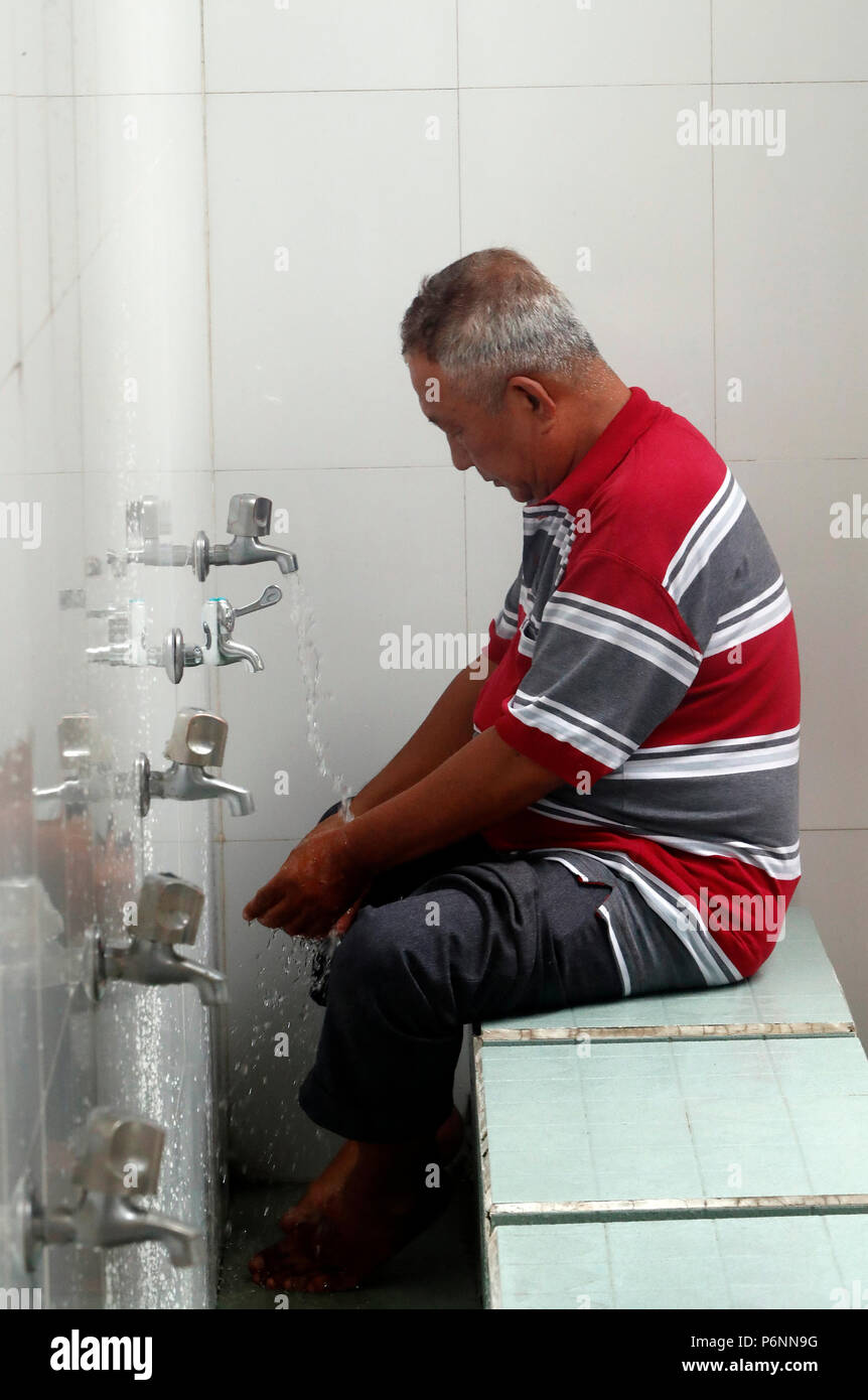 Masjid Al Rahim Mosque. Ritual purity in Islam. Muslim performing Wudu ...
