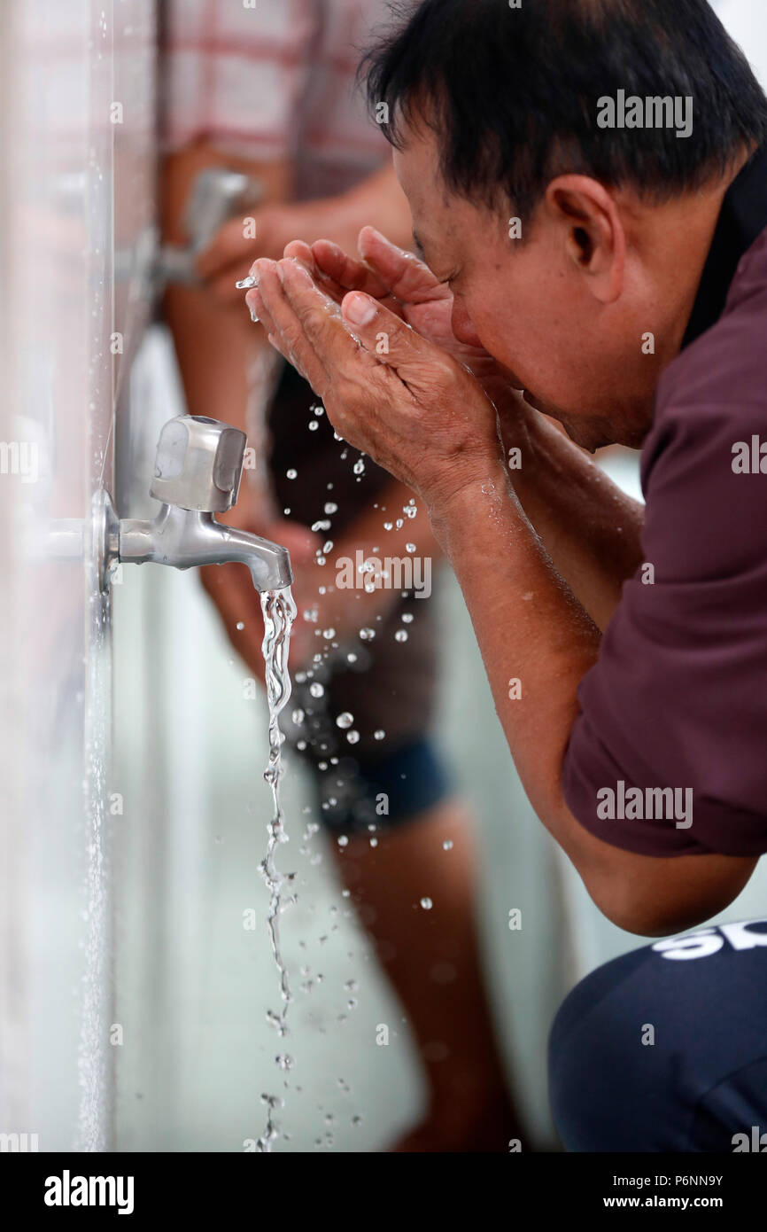 Masjid Al Rahim Mosque. Ritual purity in Islam. Muslim performing Wudu ...