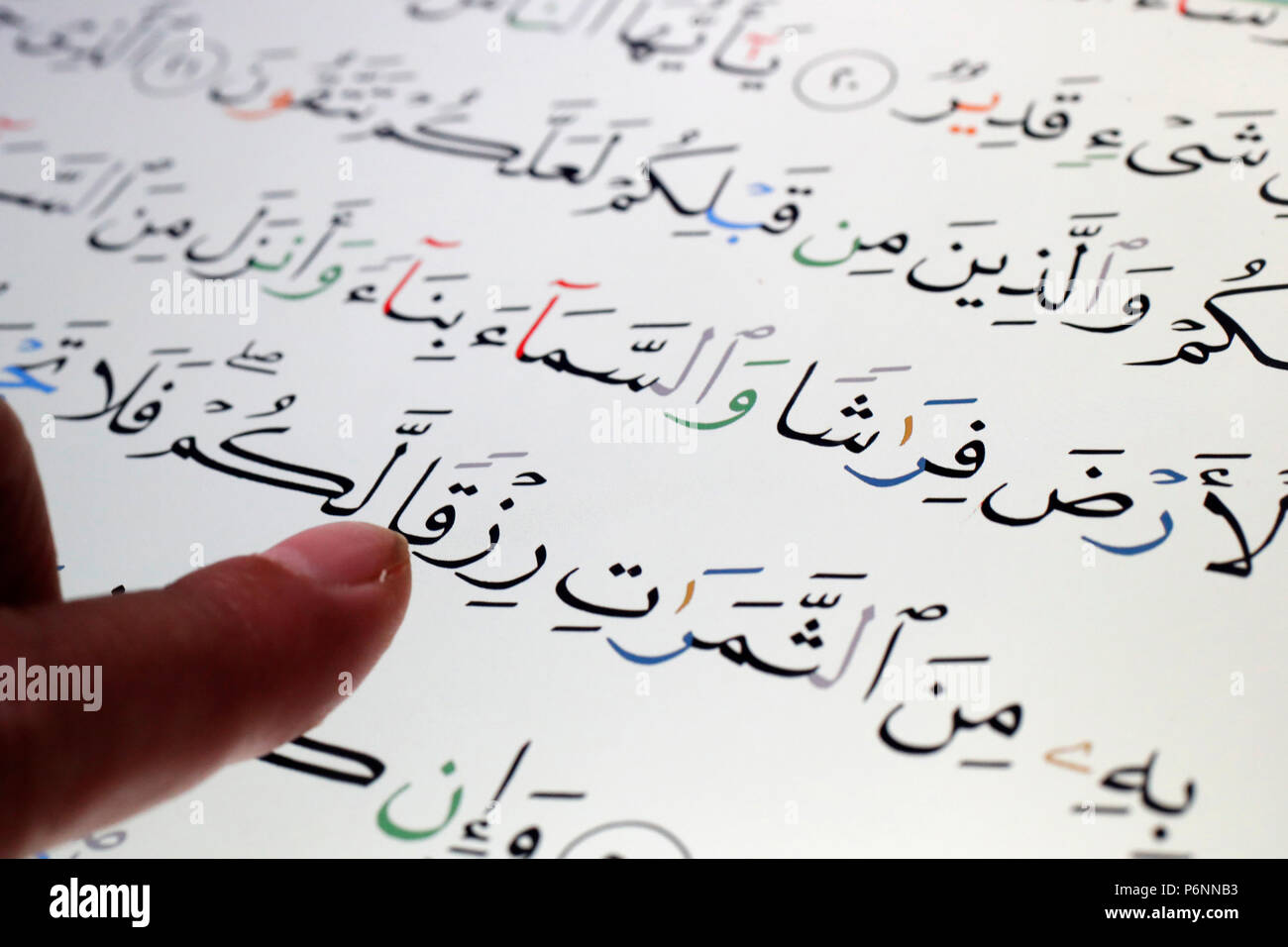 Man reading an electronic Quran on a tablet Stock Photo - Alamy