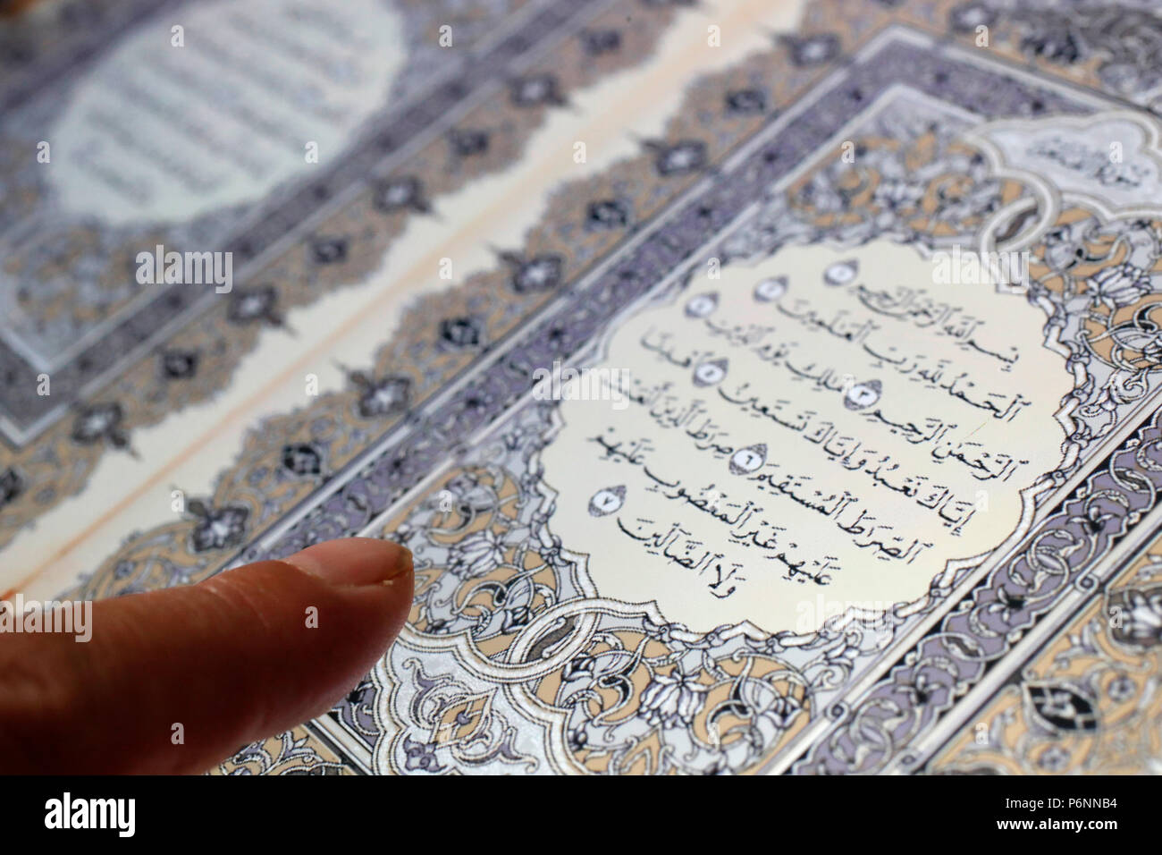 Man reading an electronic Quran on a tablet Stock Photo - Alamy