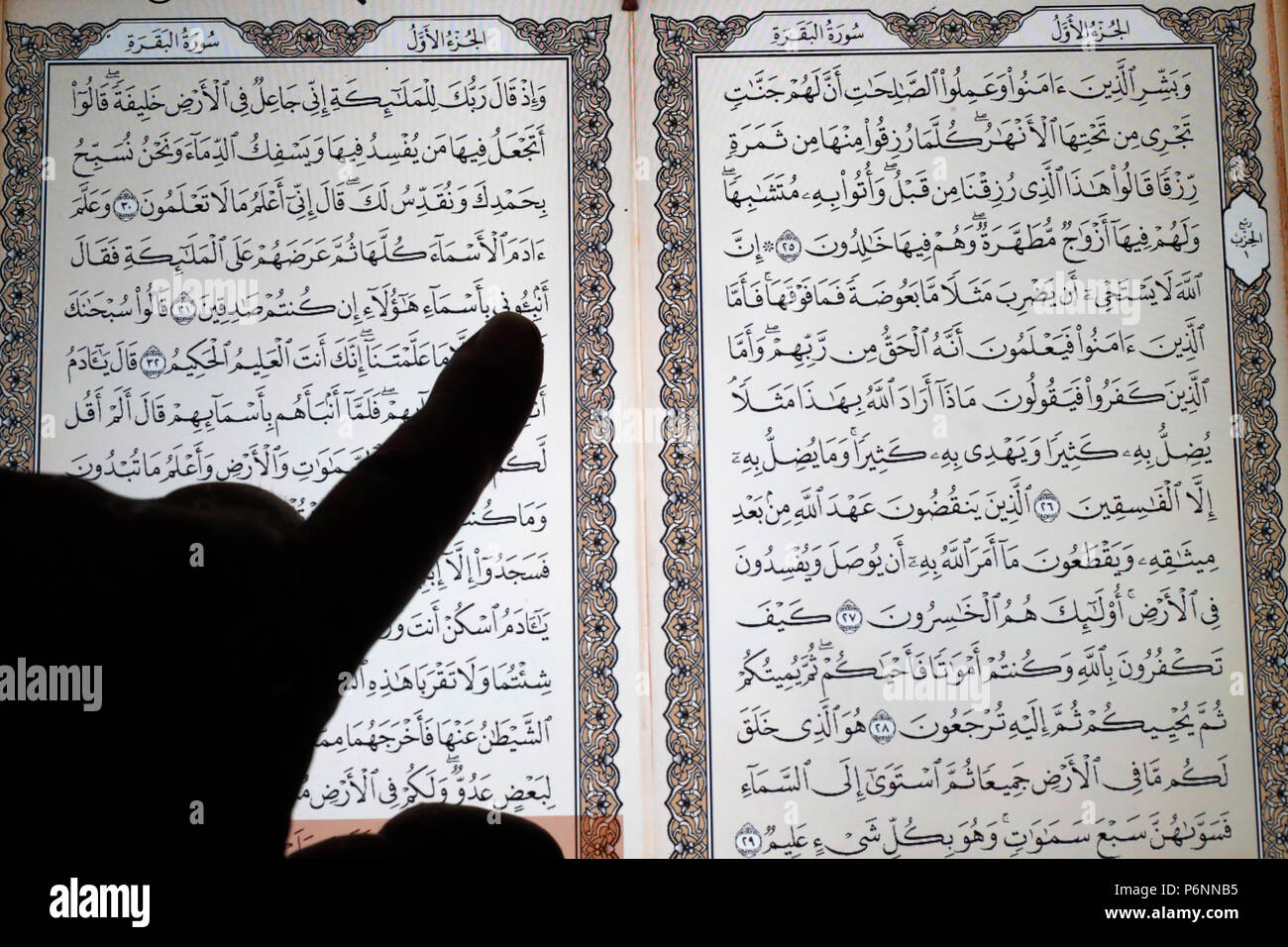 Man reading an electronic Quran on a tablet Stock Photo - Alamy