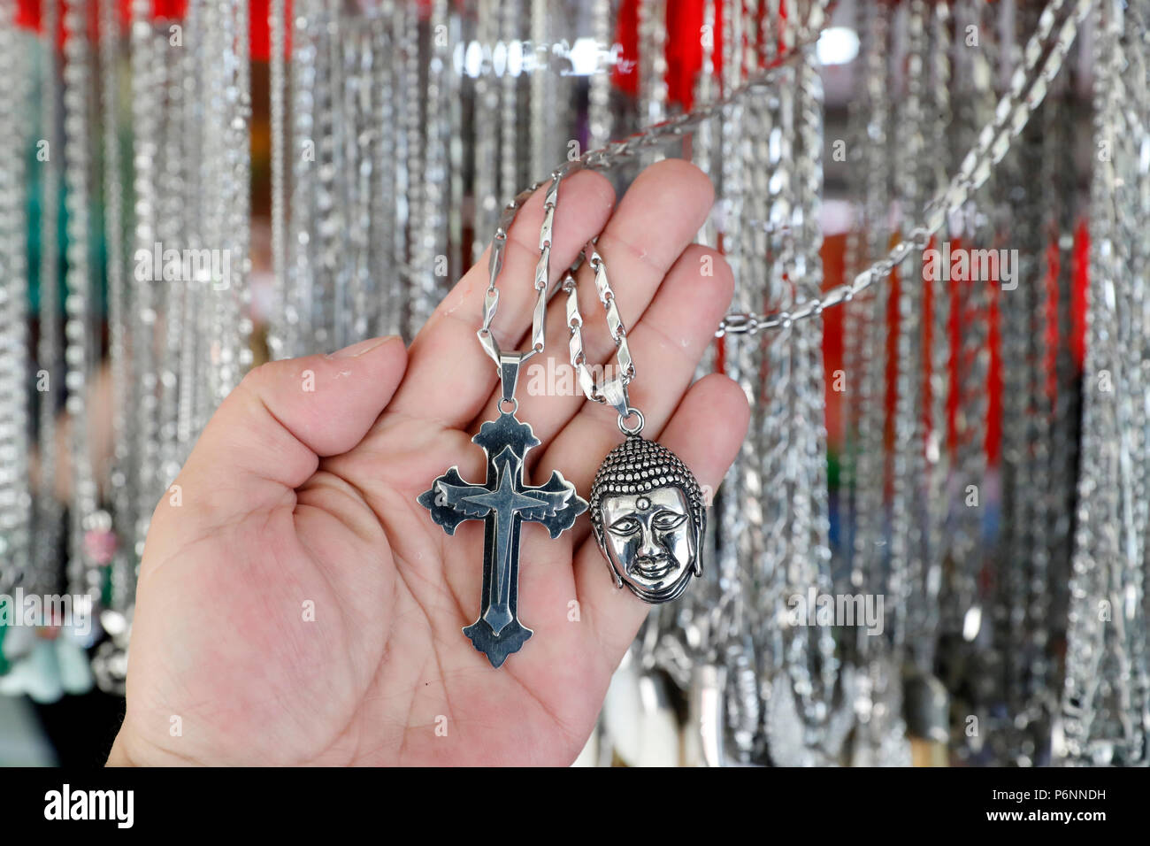 Christianity and buddhism. Buddha and christian cross in hand Stock ...