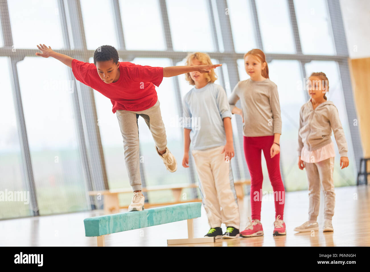 Children do school sports and balance on a balance beam Stock Photo - Alamy