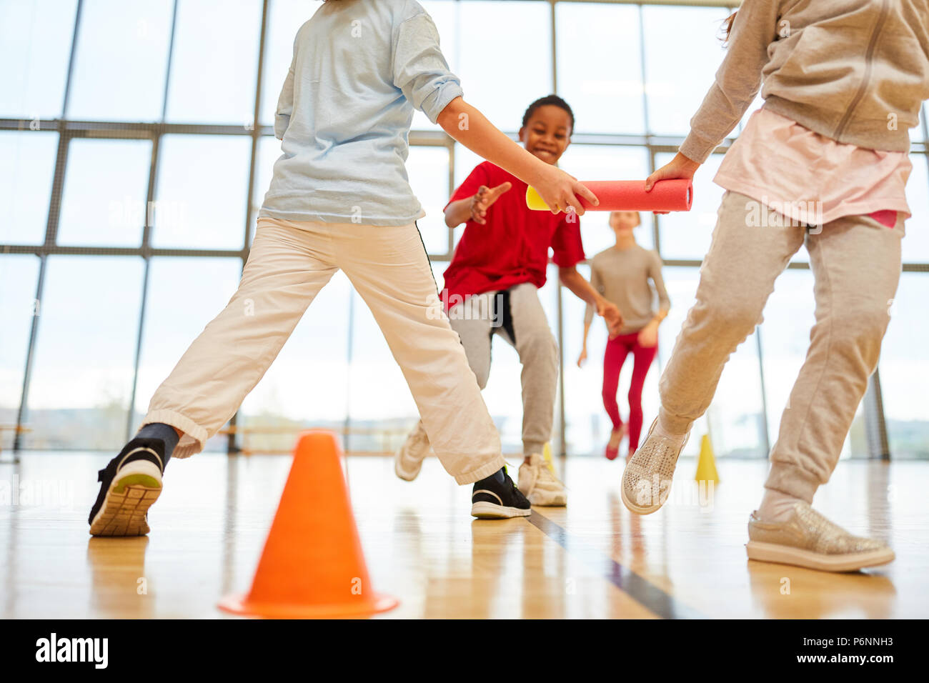 Children's team makes a relay race in physical education in the gym ...