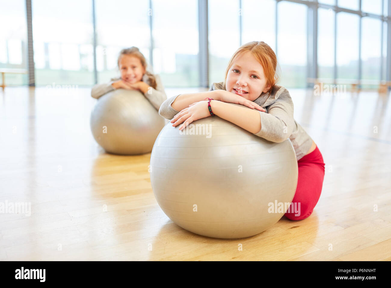 Girls take a break in physical education and rely on gym ball Stock ...