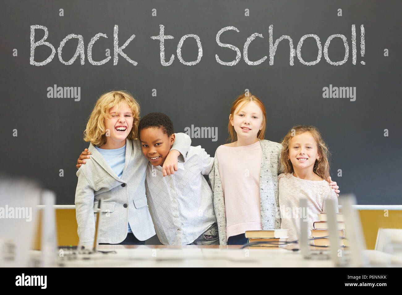 Group of pupils stands at the beginning of school in front of a ...