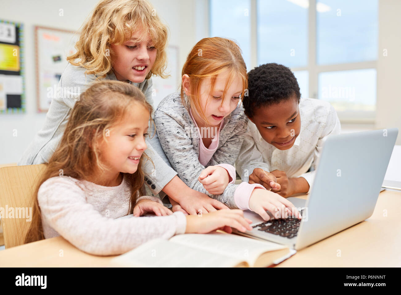 Group of kids at laptop computer learn how to deal with social media ...