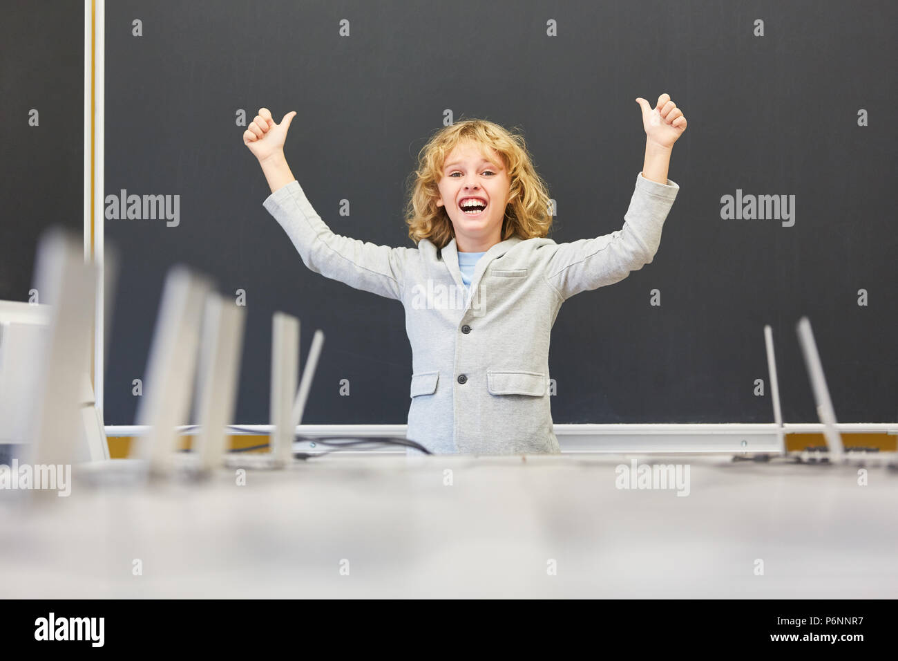Students cheering in classroom hi-res stock photography and images - Alamy
