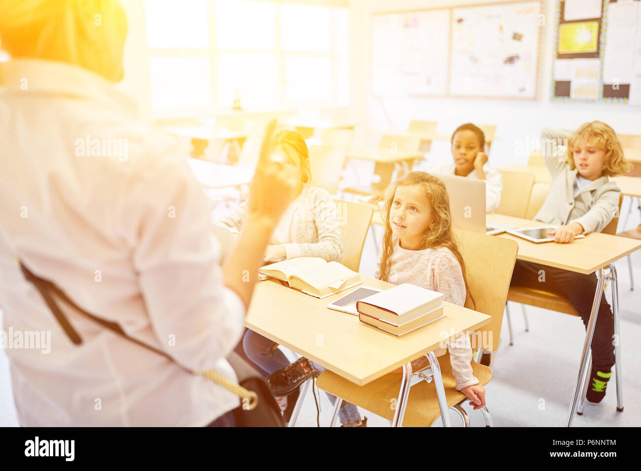 Pupils sit with tablet computer in primary school classroom Stock Photo ...