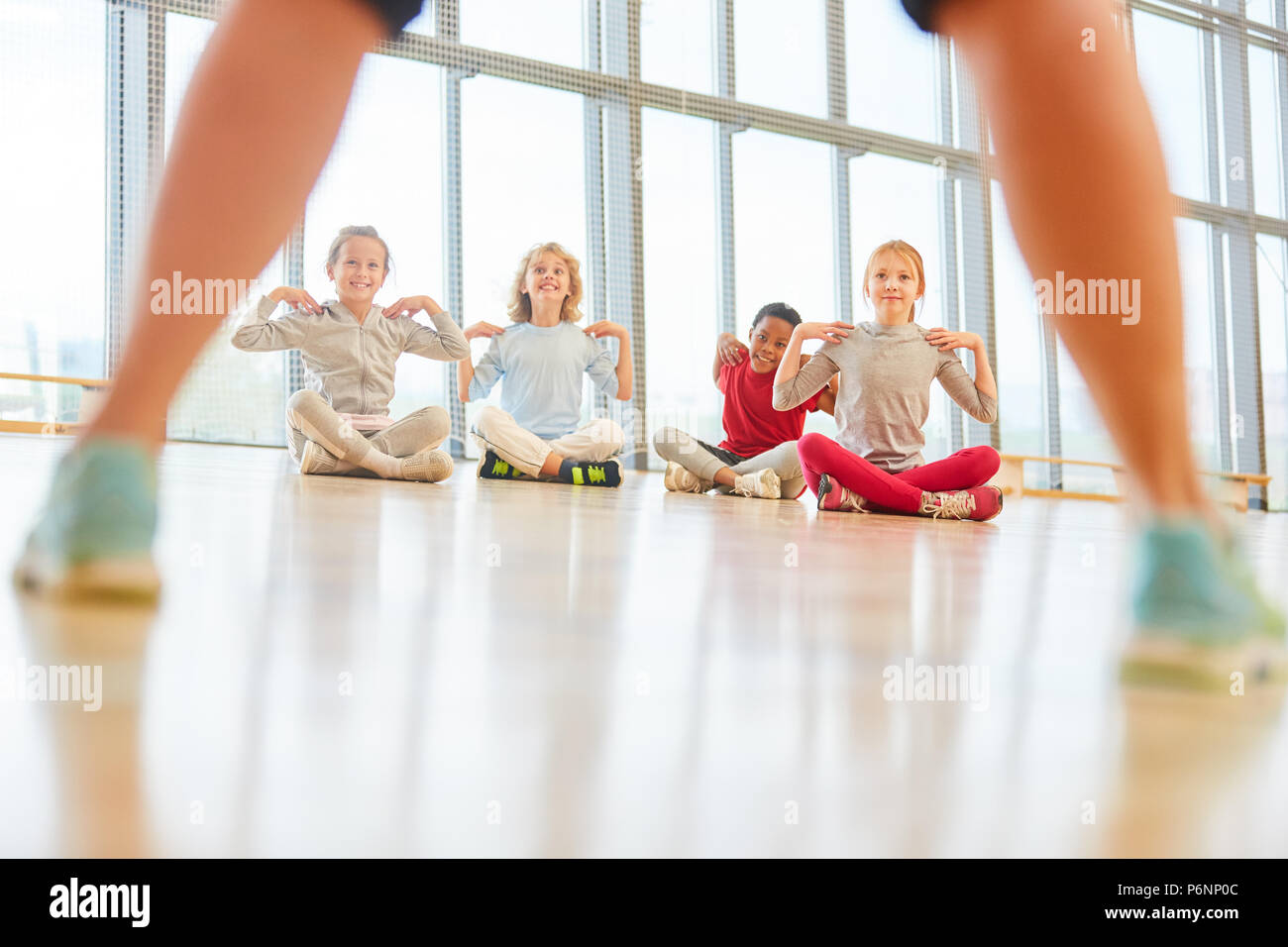 Group of students doing healthy stretching and gymnastics in physical ...