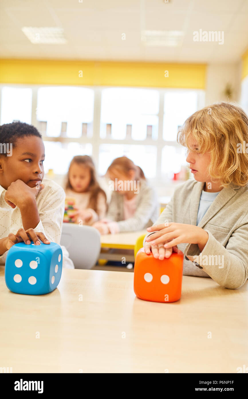 Two boys learn together expect a dice game in preschool Stock Photo - Alamy