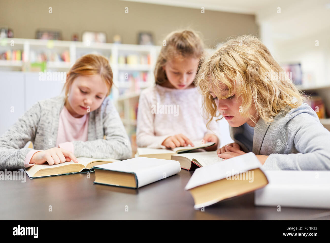 Students read together in a study group in the primary school library ...