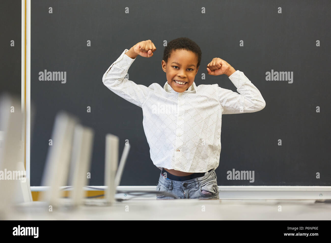 Self-confident student posing as a winner in front of an empty ...