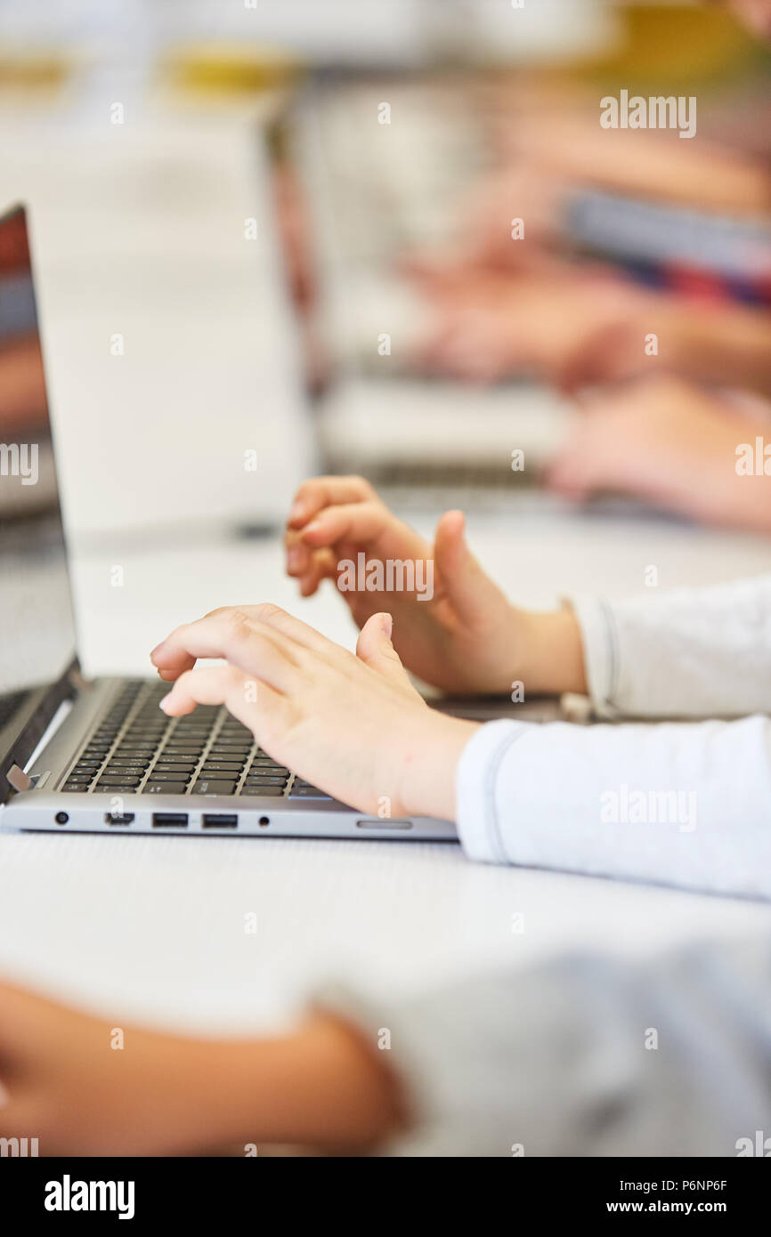 Pupils learning at laptop Computer online computer science in a primary ...