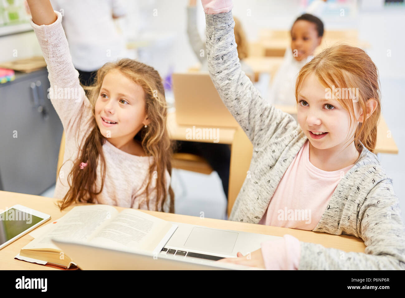 Children as students in elementary school lessons answer questions from ...