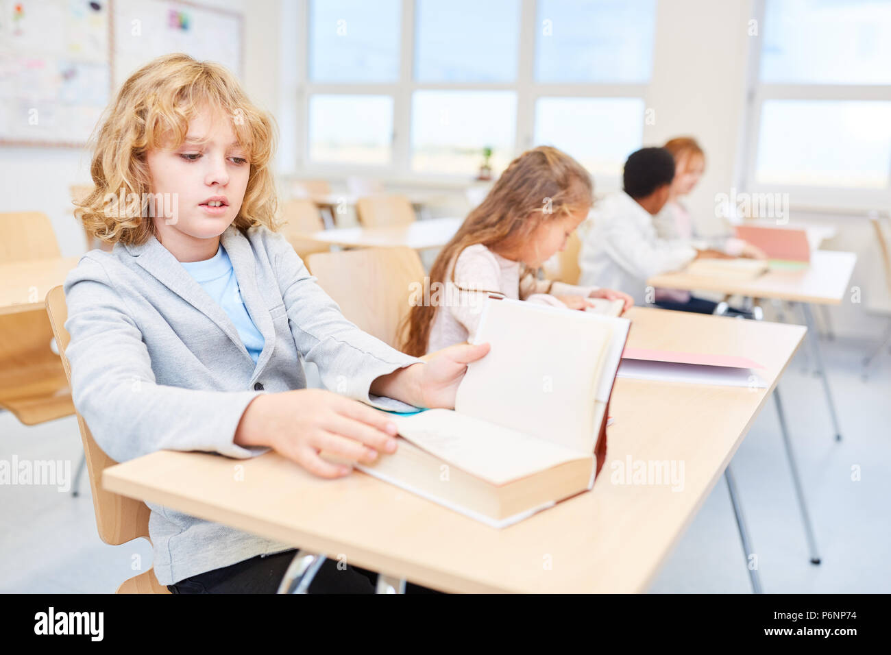 Children as elementary school students learn in class or in an exam ...