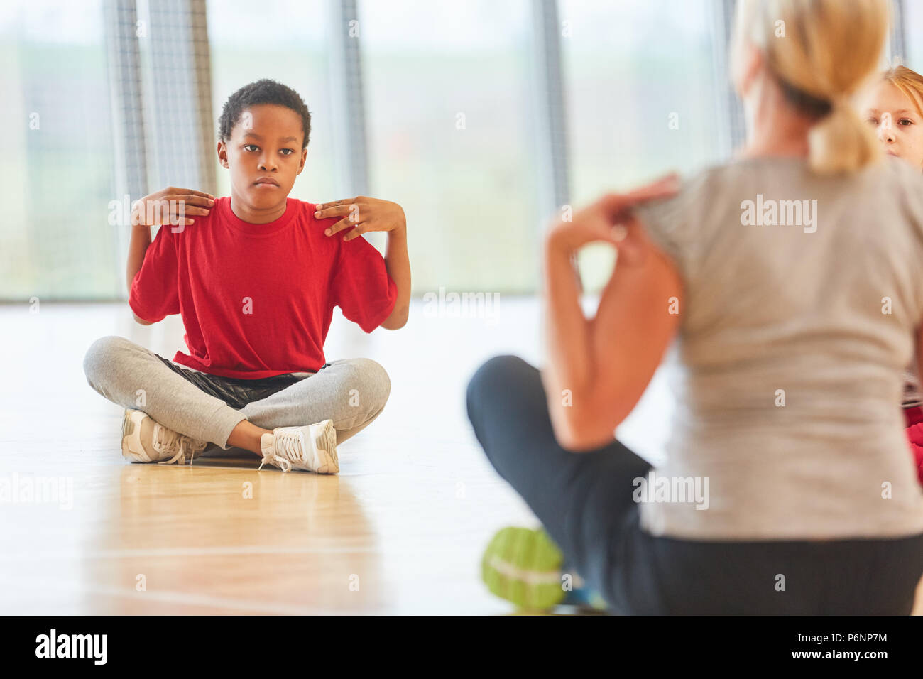 African boy is doing a healthy stretching exercise in physical ...