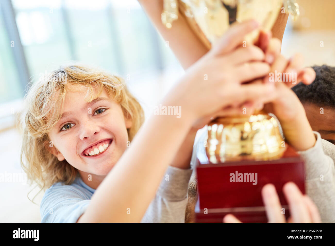 Happy boy as winner gets a cup after a sports competition Stock Photo ...