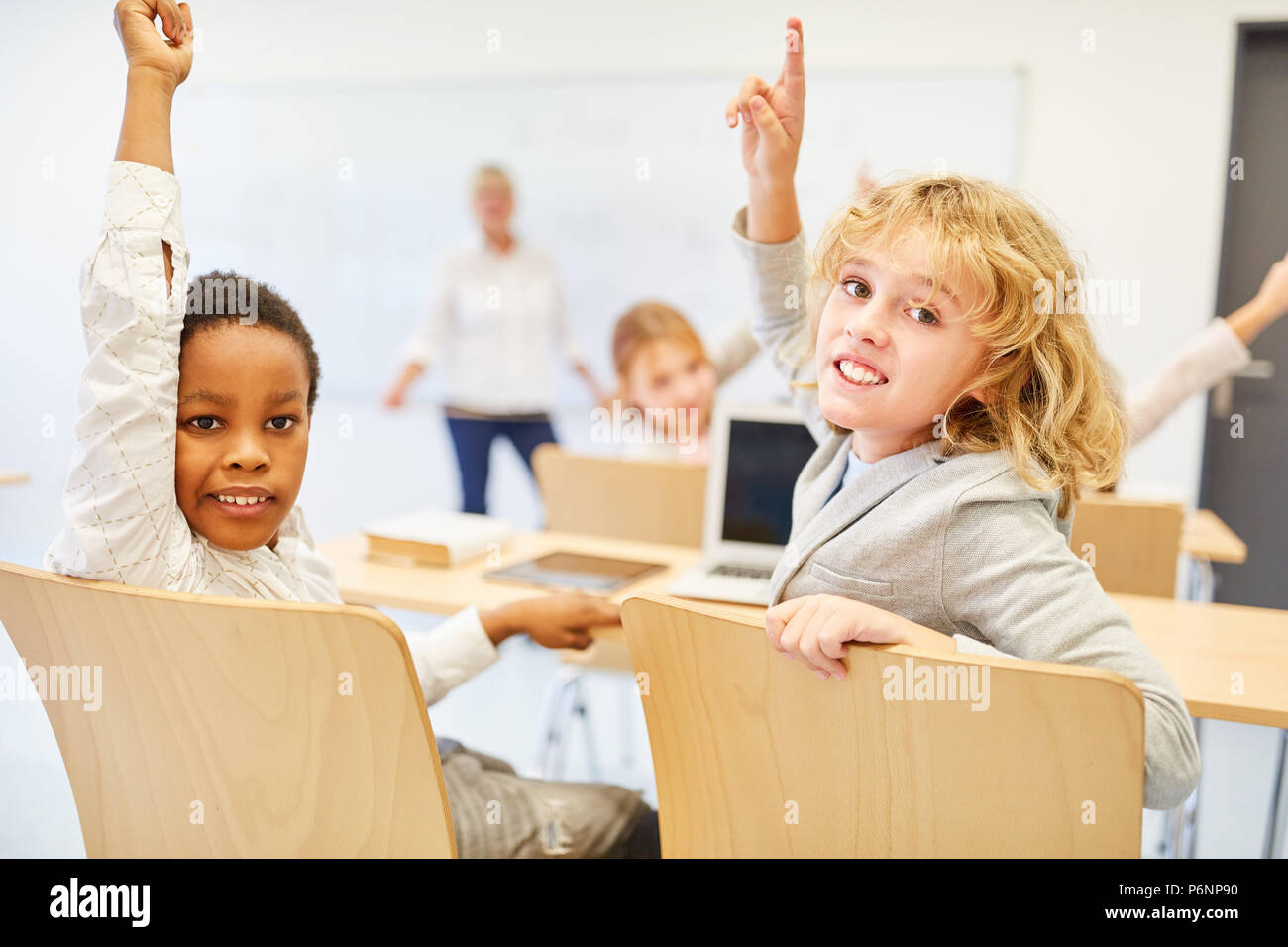 Two boys as students have an answer and report in class Stock Photo - Alamy