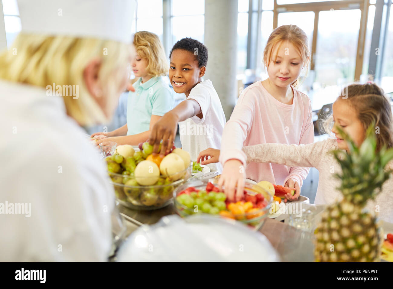 Students at the cafeteria or canteen's buffet get fresh fruit Stock ...