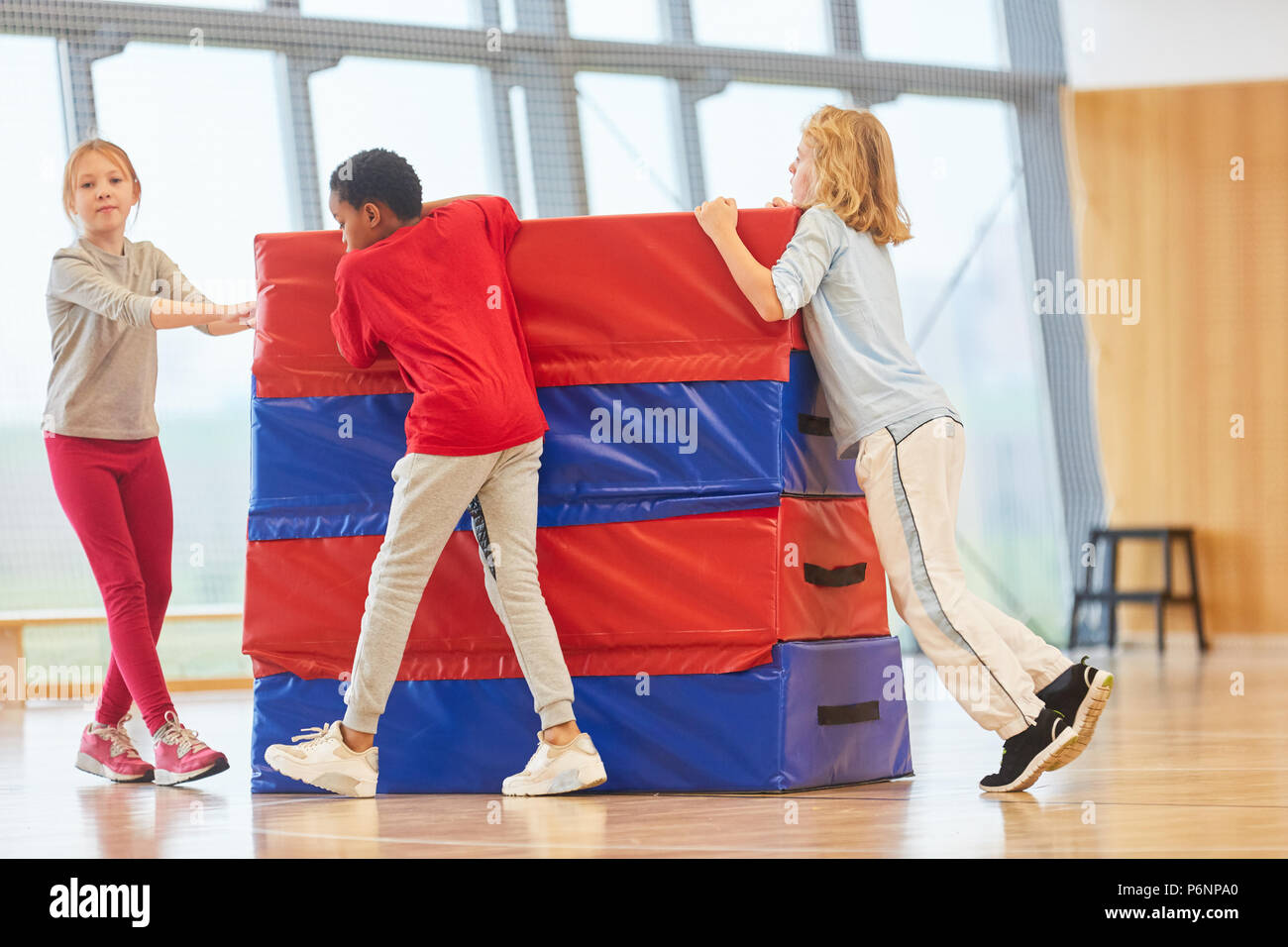 Pupils in physical education in the gym of elementary school with ...