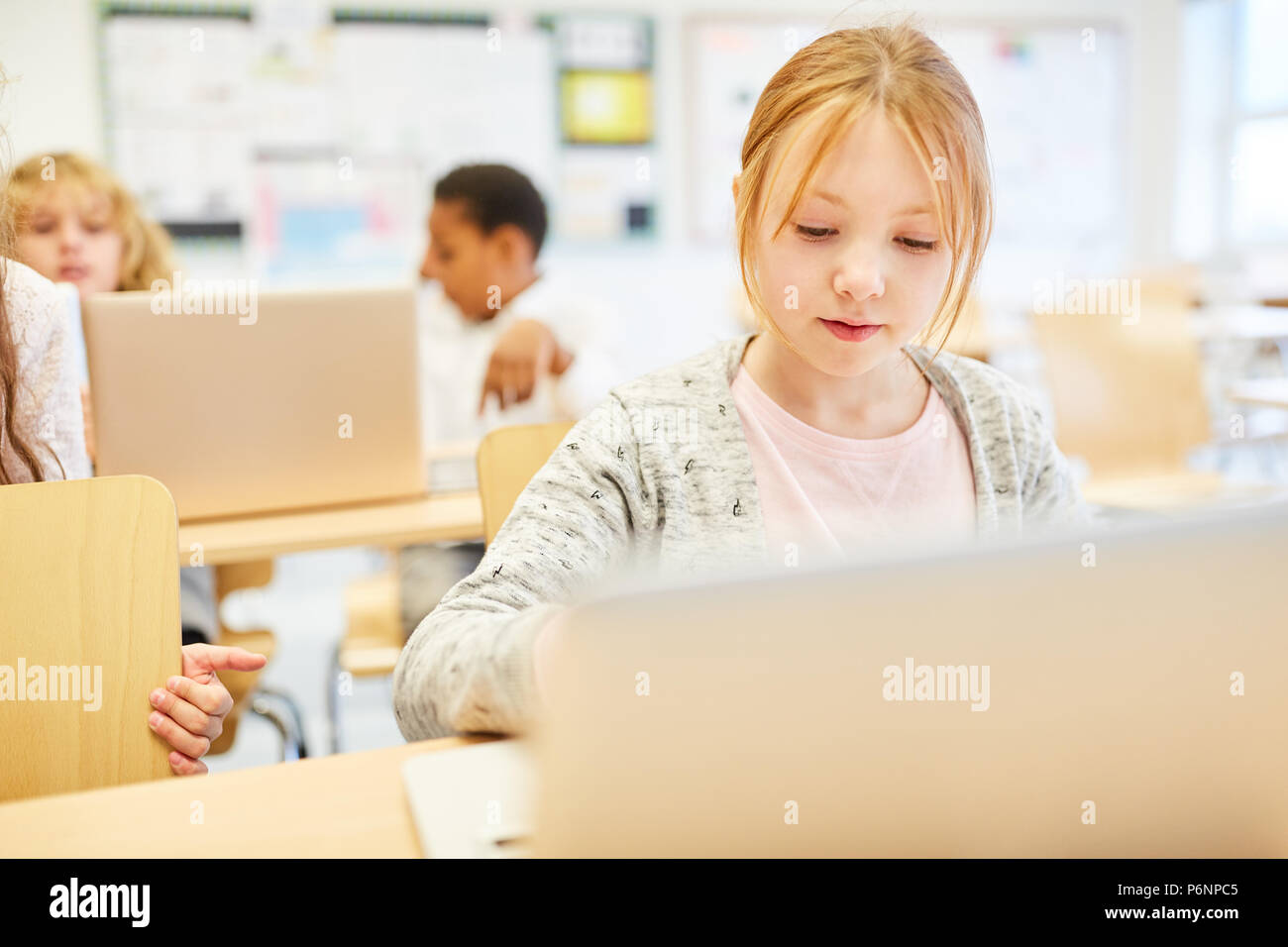 Girl concentrates on laptop computer in computer science class Stock ...
