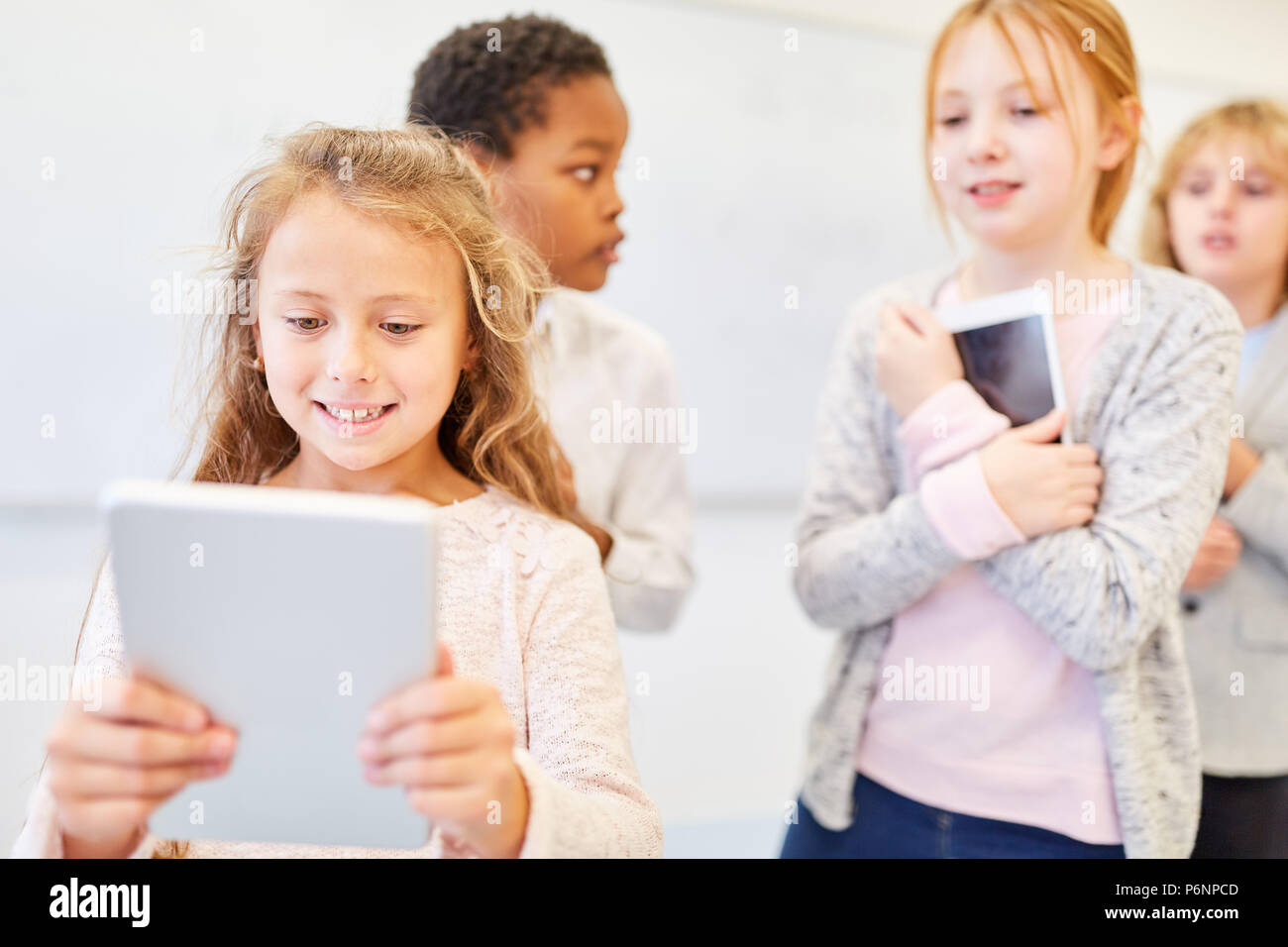 Group of students learns how to use digital media with the tablet ...