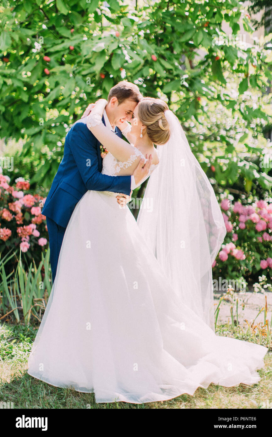 Stylish groom hugging lovely hi-res stock photography and images - Alamy
