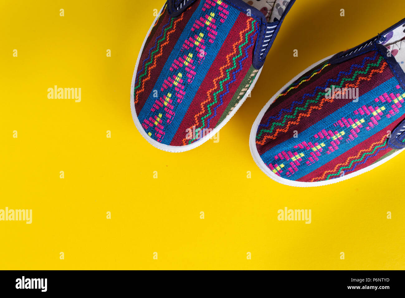 bright multi-colored women's shoes on a yellow background. comfortable ...
