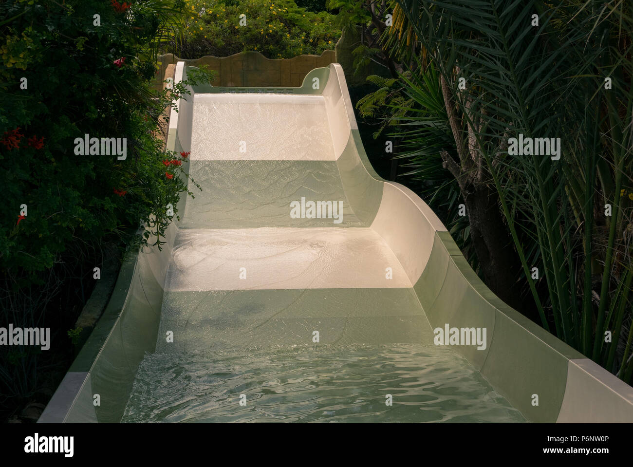 Striped empty water slide Stock Photo - Alamy