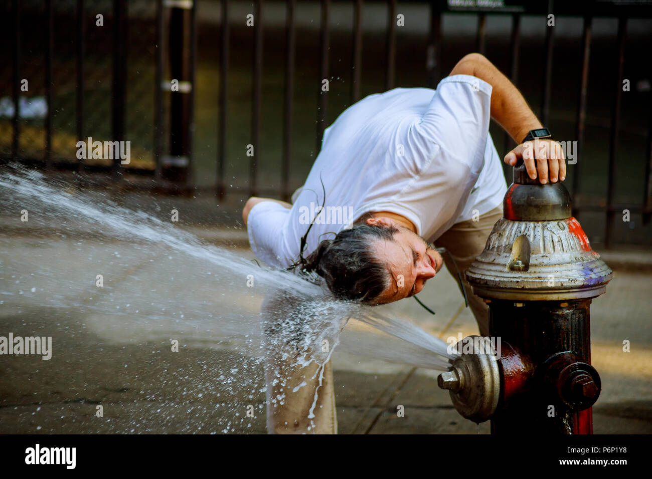 A strong heat temperature and the man is refreshed with water from a ...