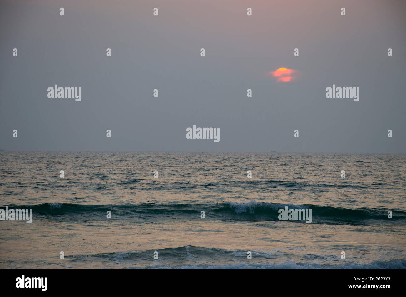 Beautiful landscape sunset with at the sea blue with the red sun and ...
