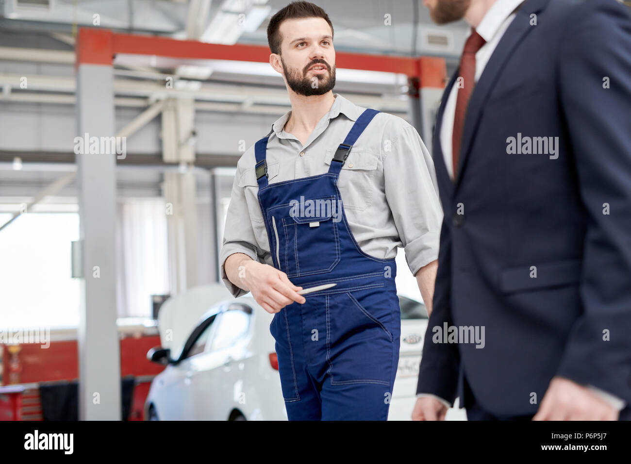 Mechanic Giving Tour of Car Factory Stock Photo - Alamy