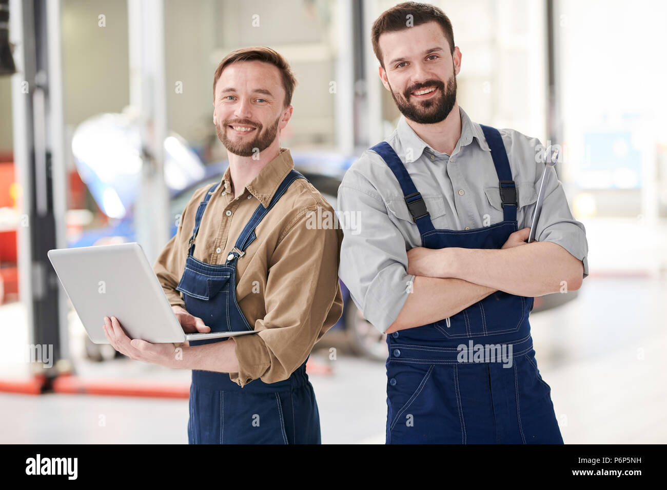 Two Modern Mechanics Posing Stock Photo - Alamy