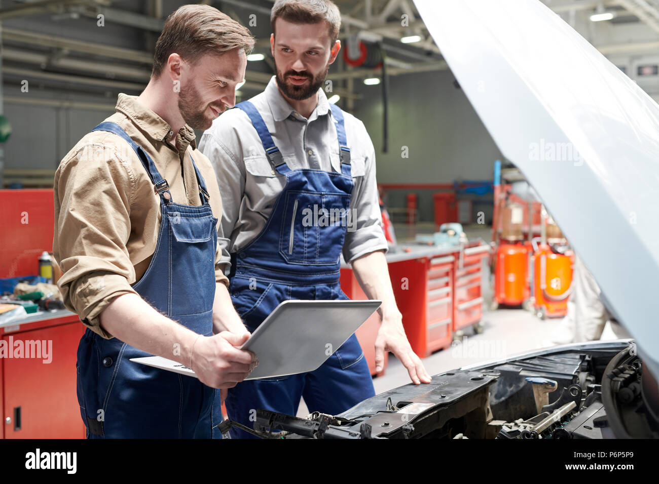 Two Mechanics Repairing Car Stock Photo - Alamy