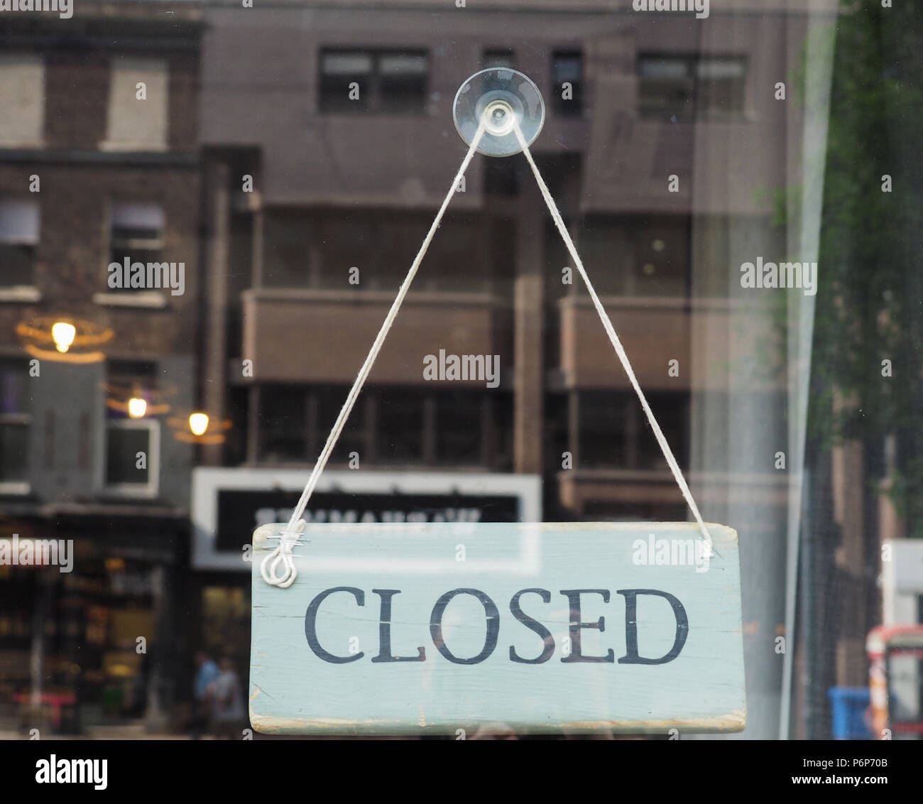Closed sign in a shop showroom with reflections Stock Photo - Alamy