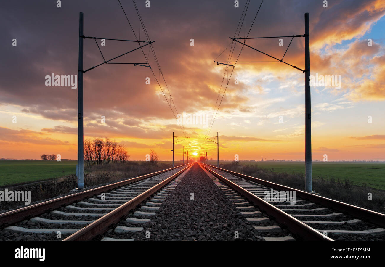 Railroad at a dramatic sunset Stock Photo - Alamy
