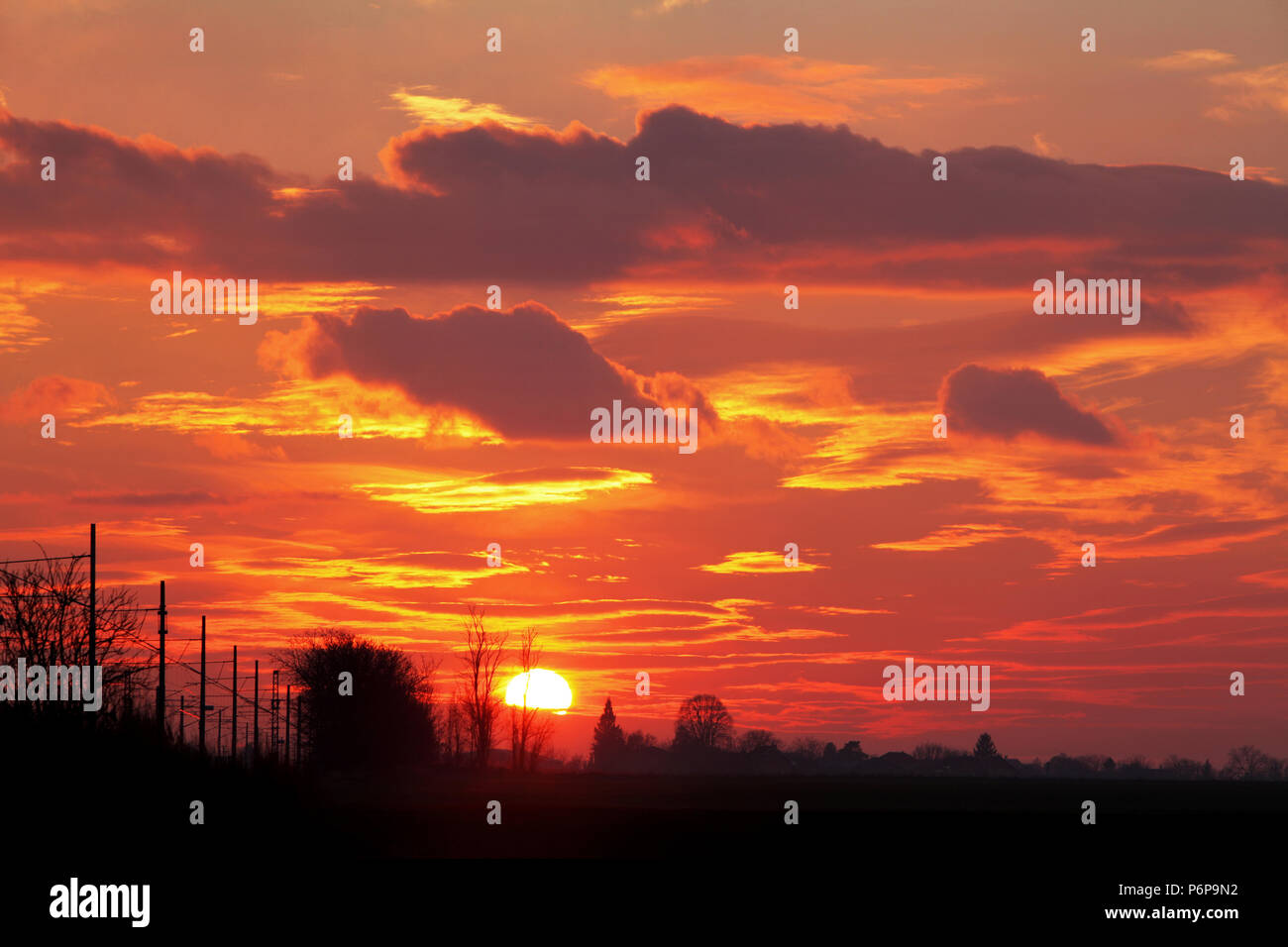 Sunset sky with dramatic clouds and red sun Stock Photo - Alamy