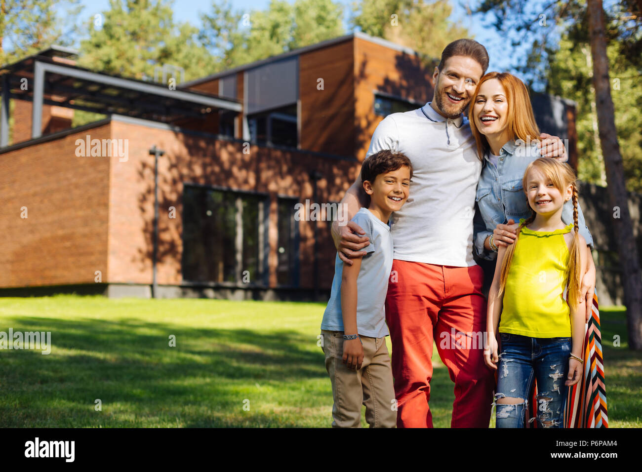 Alert man hugging his family Stock Photo - Alamy